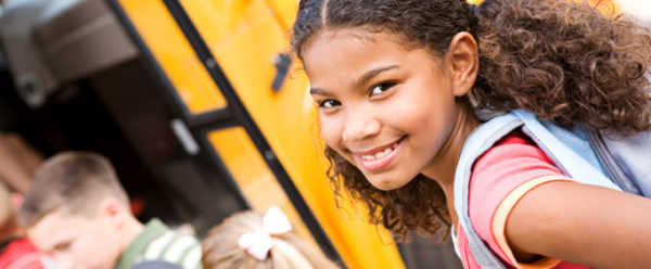 Girl Getting on a School Bus – AAA Exchange
